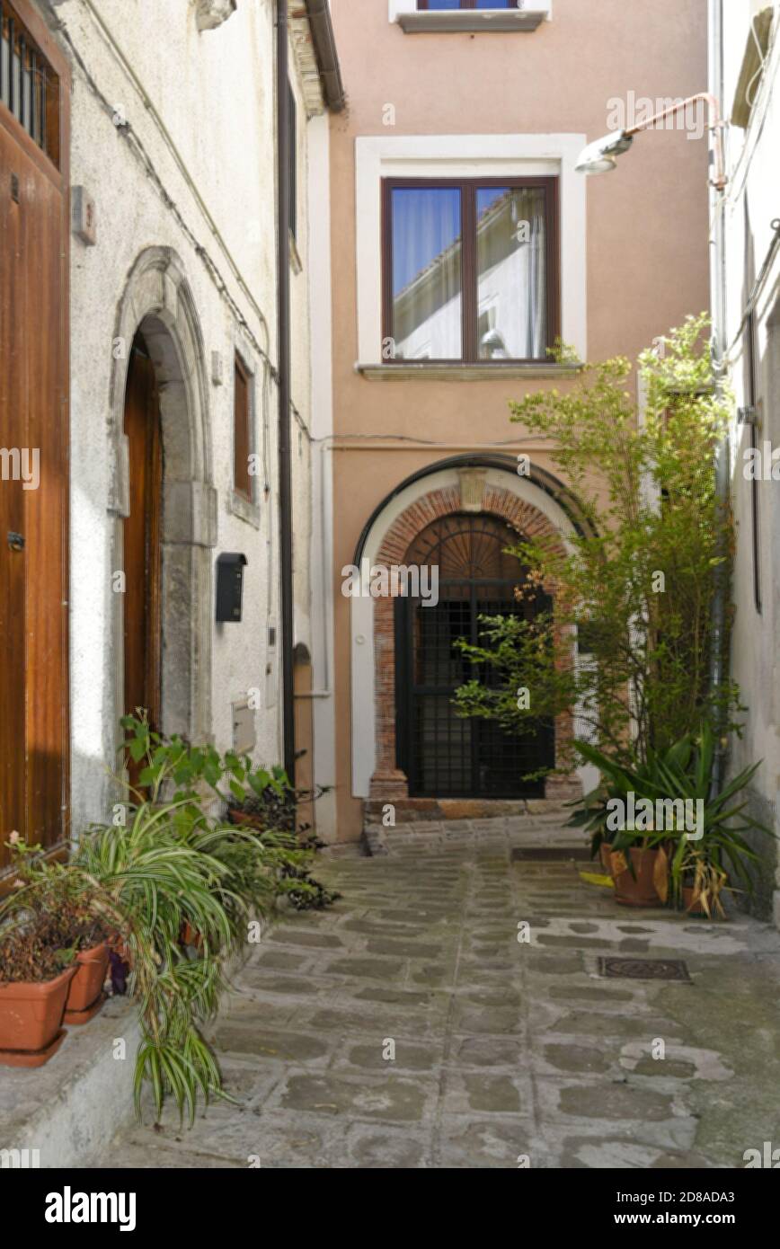 A narrow street among the old houses of Viggiano, a medieval village in ...