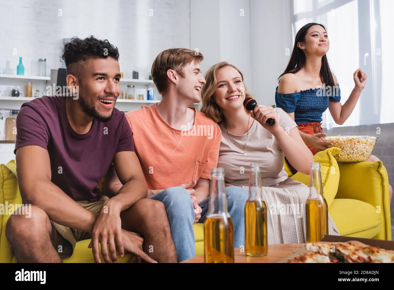 selective focus of asian woman holding bowl of popcorn while ...