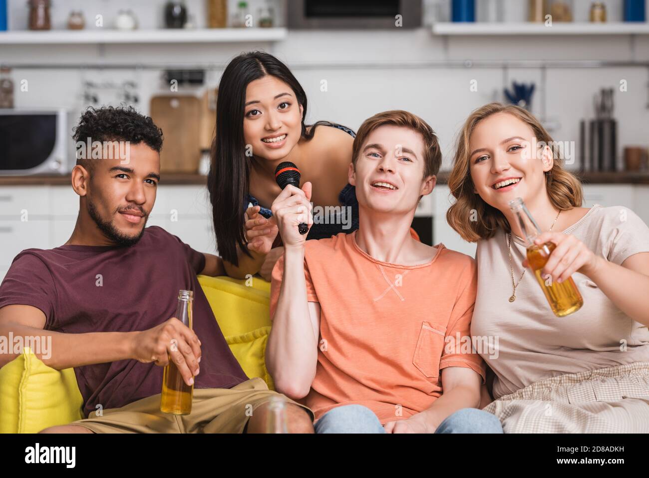 Happy friends singing karaoke party hi-res stock photography and images ...