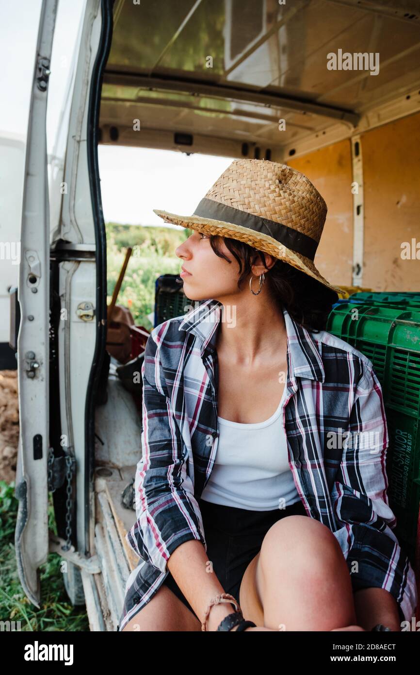 Young farmer woman resting in a van at crop field Stock Photo - Alamy
