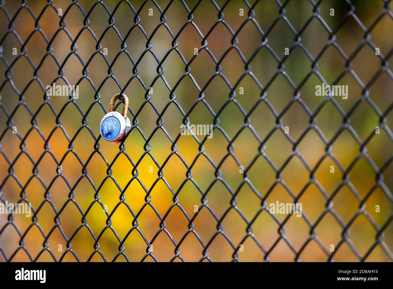 A combination lock on a fence Stock Photo - Alamy