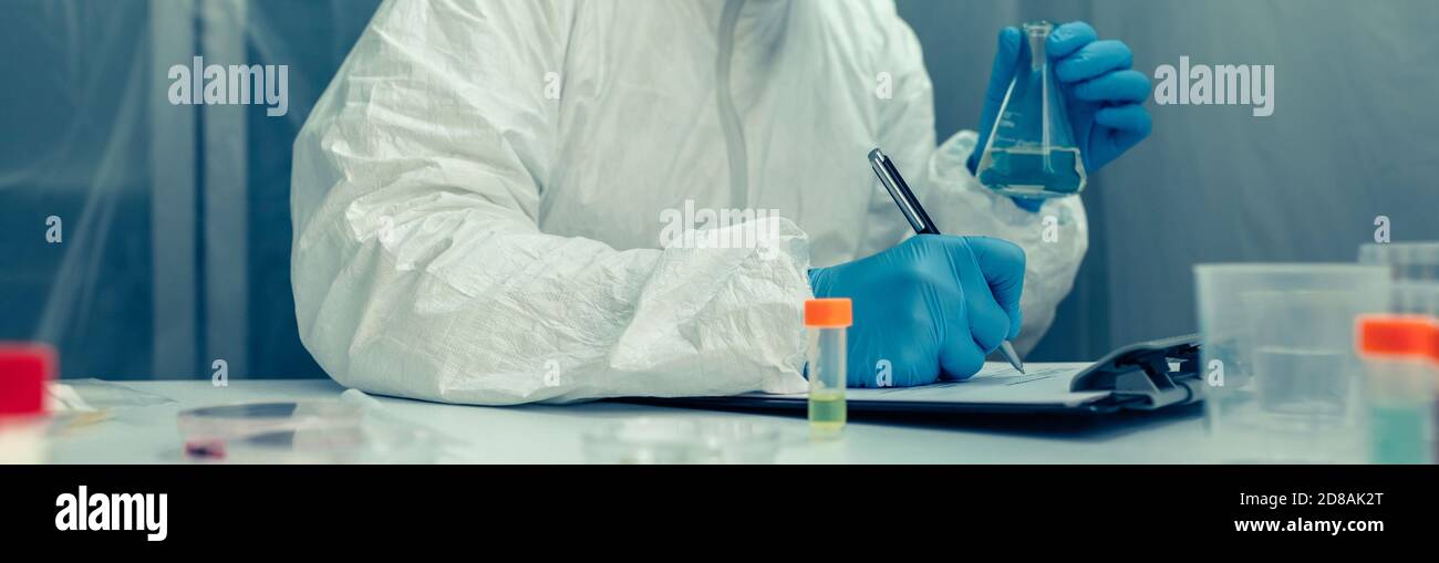 Scientist with protection suit investigating in the laboratory Stock ...