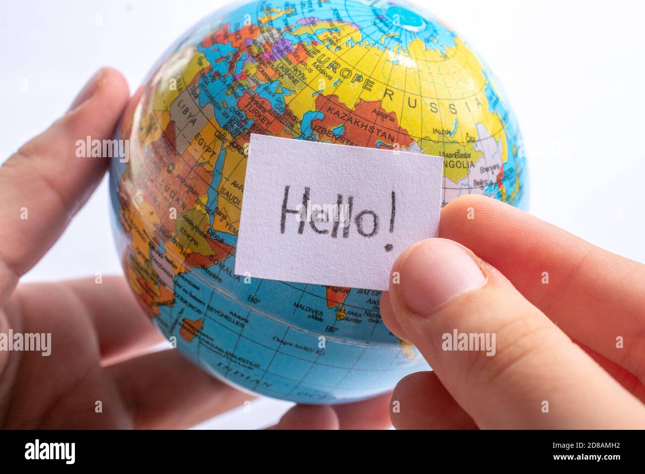Hand holding notepaper with HELLO wording on model globe Stock Photo ...