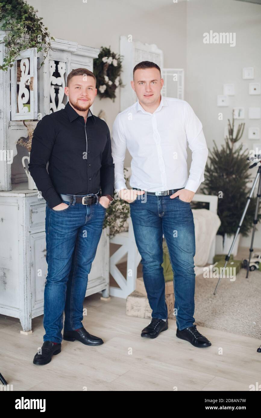 Two good male friends at the New Year's corporate posing for the camera ...