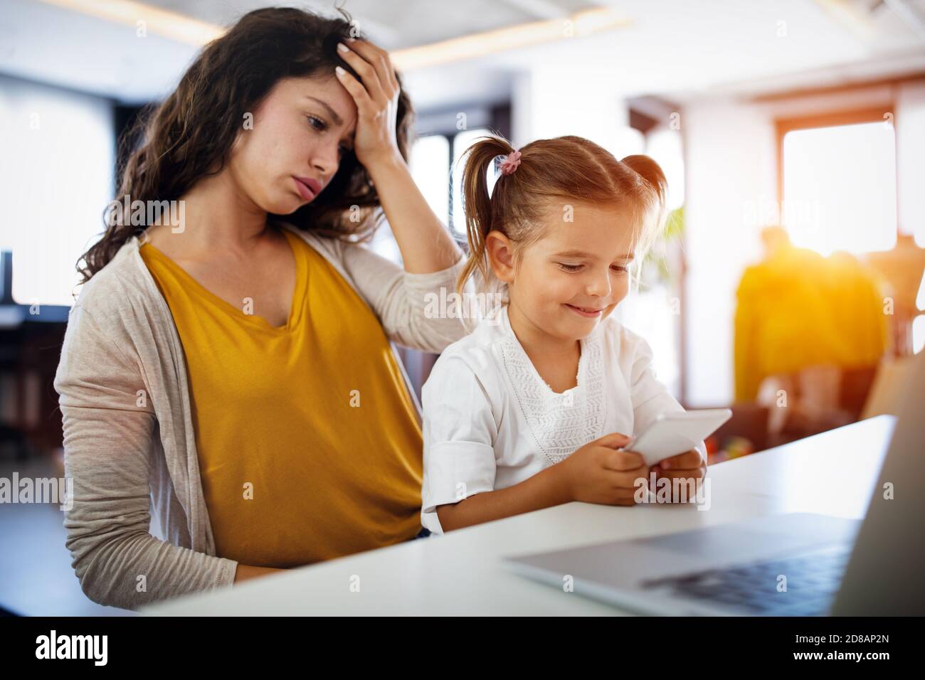 Tired stressed out mom with game and technology addicted child Stock ...