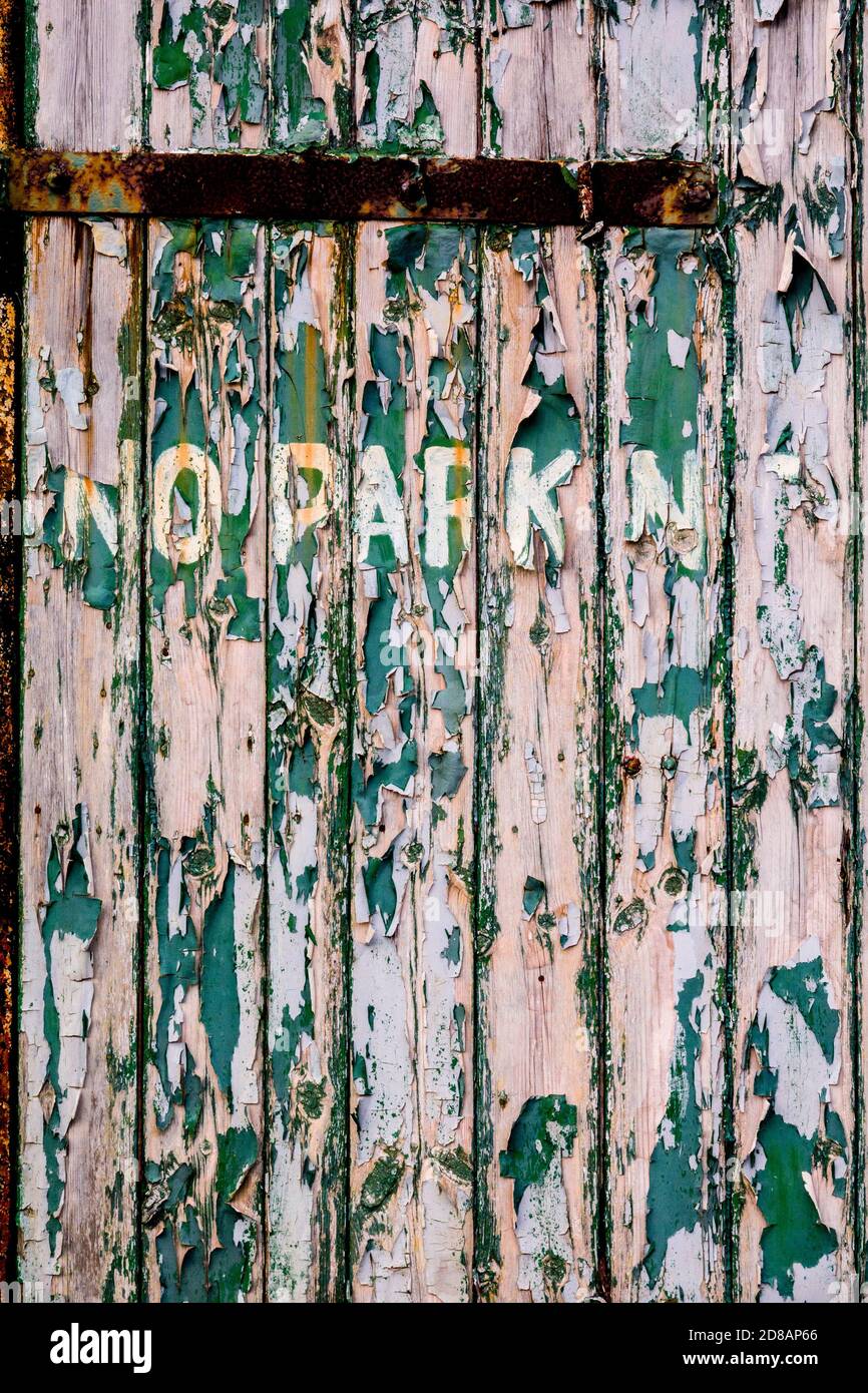 Door with piling piant with no parking sign Stock Photo - Alamy