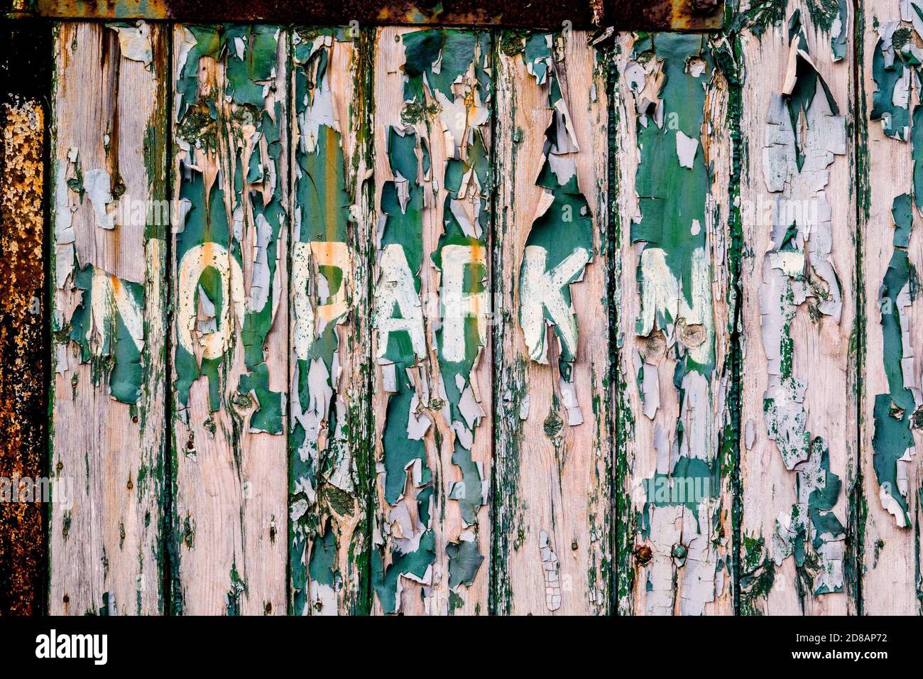 Door with piling piant with no parking sign Stock Photo - Alamy