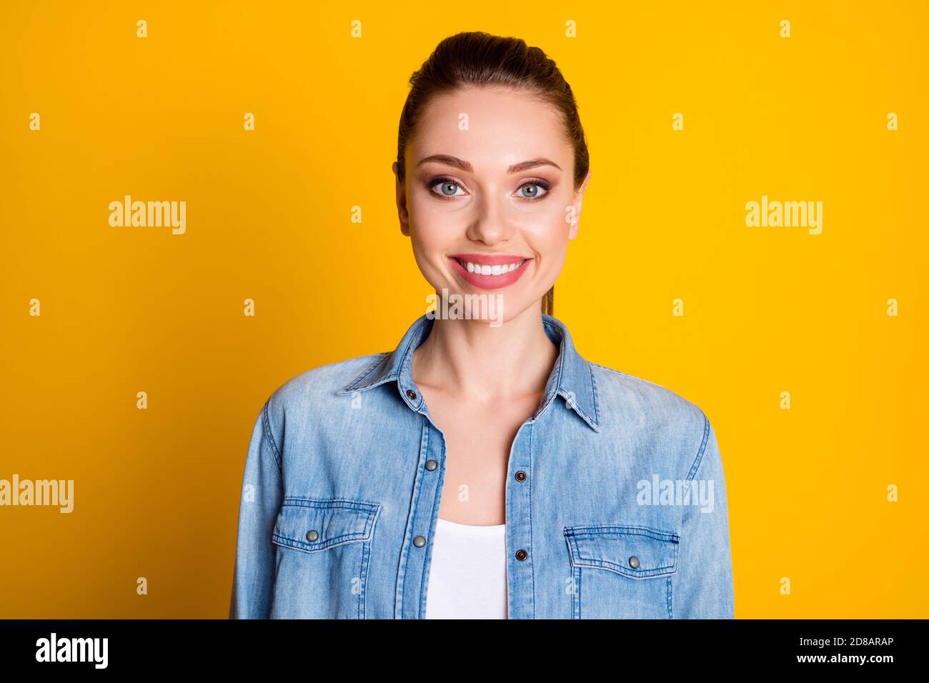 Portrait of positive cheerful candid girl look in camera toothy smile wear denim shirt isolated ...