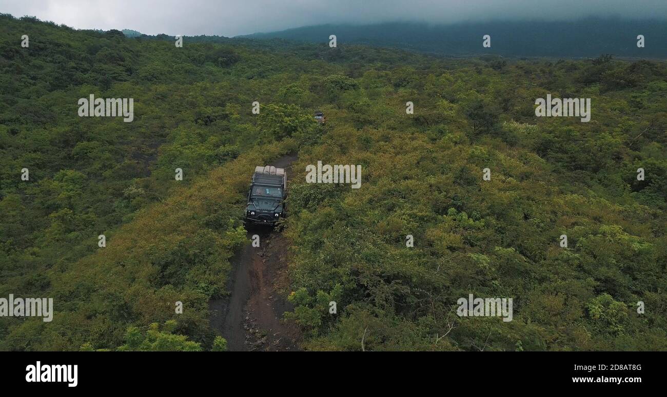 Cars driving along the black volcanic sand to Pacaya volcano in ...