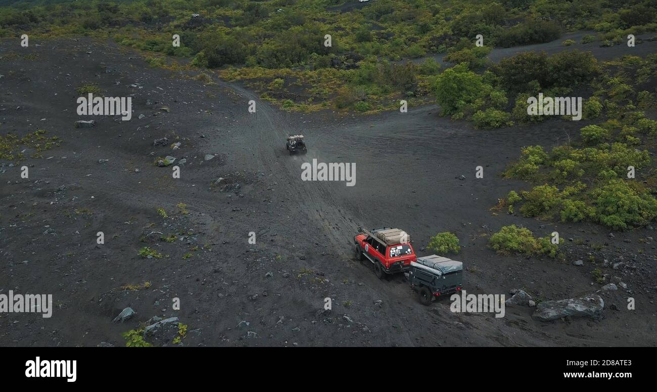 Cars driving along the black volcanic sand to Pacaya volcano in ...