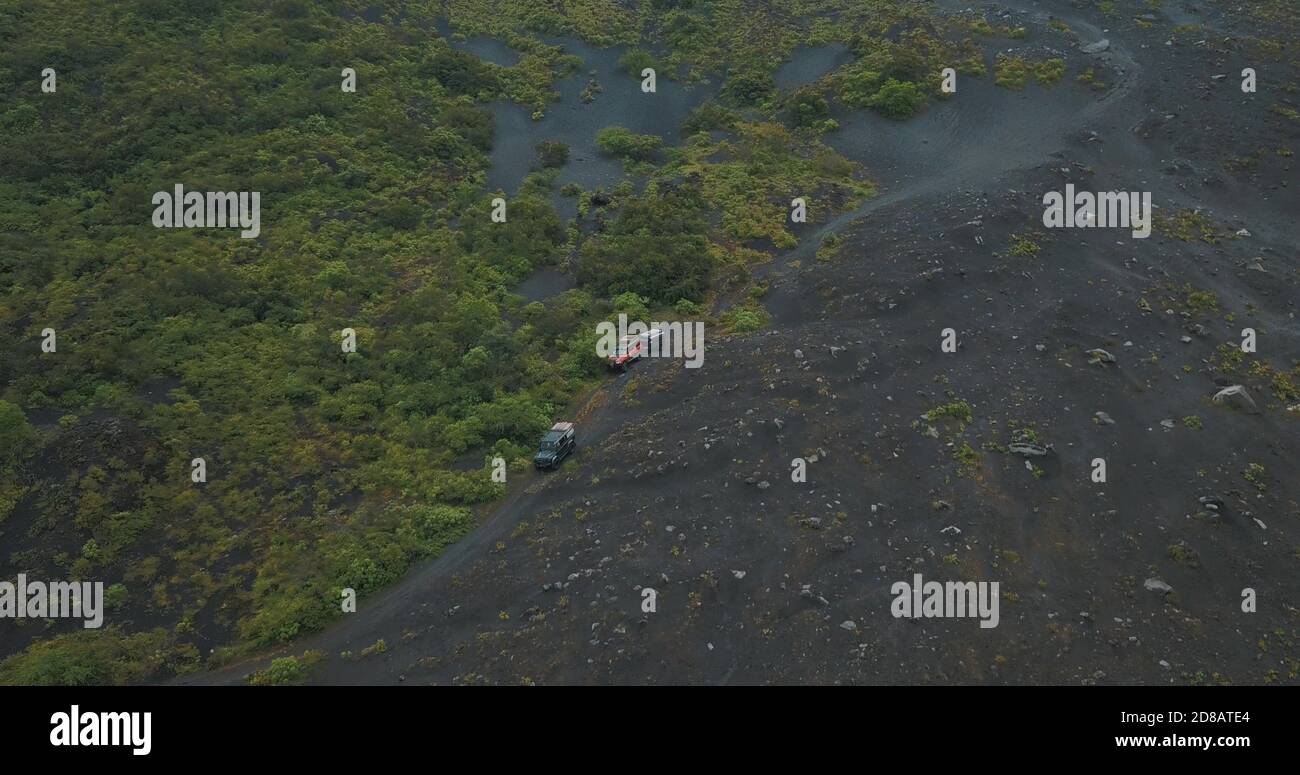 Cars driving along the black volcanic sand to Pacaya volcano in ...