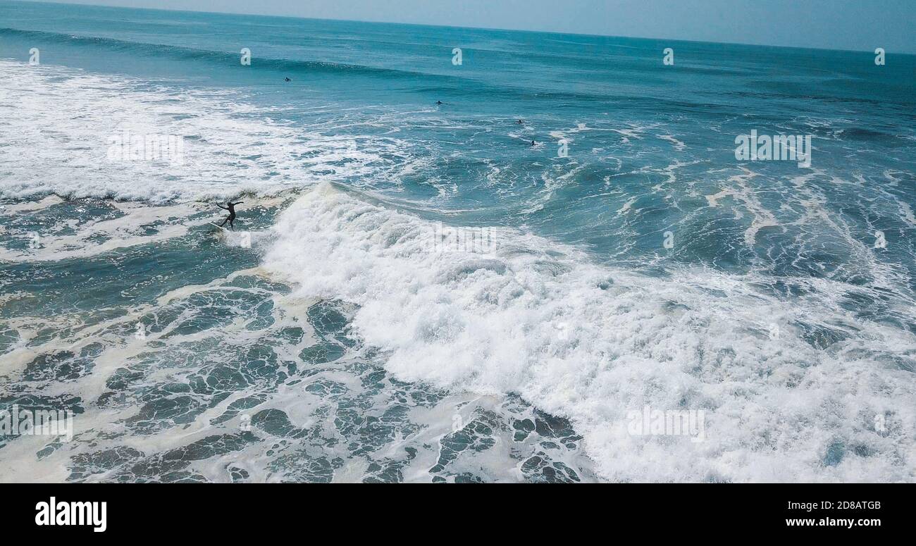 Mesmerizing shot of a surfer at the top of the wave in El Paredon beach ...