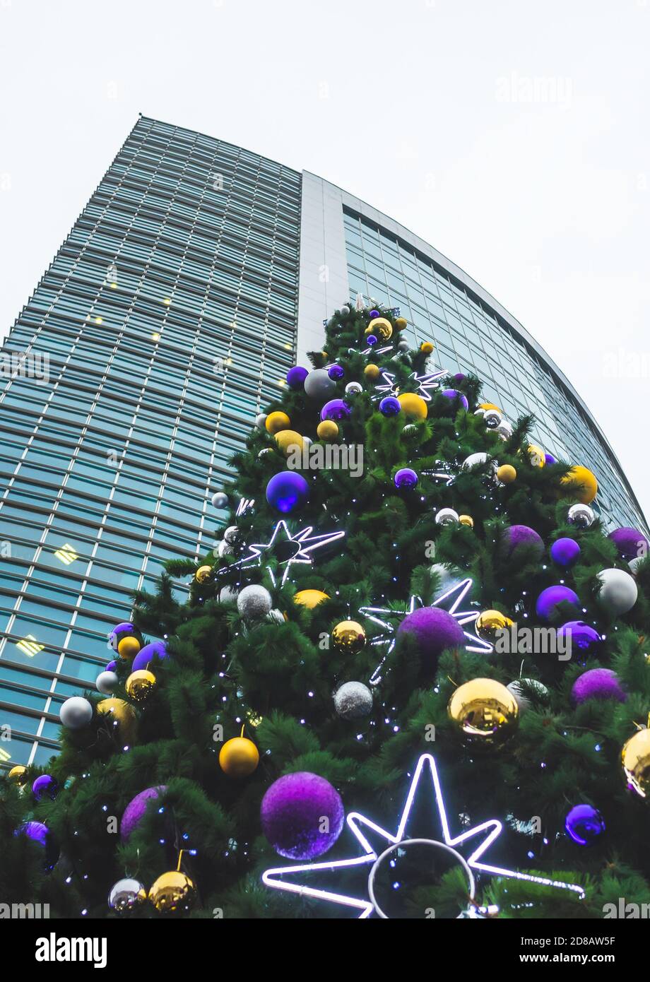 Christmas tree on the background of a skyscraper covered in fog Stock ...
