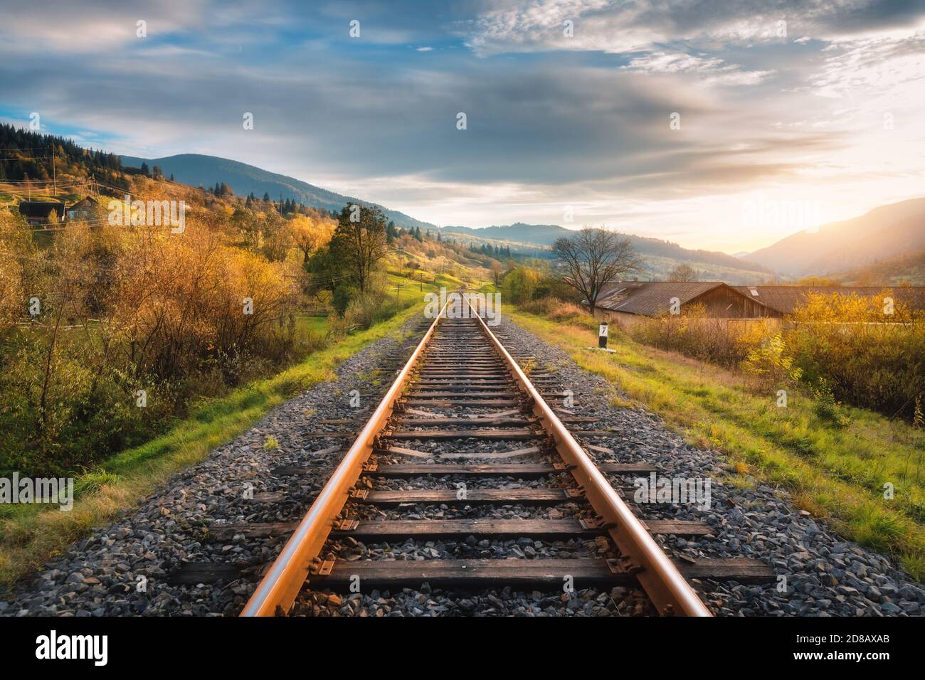 Railroad in mountains at sunset in autumn Stock Photo - Alamy