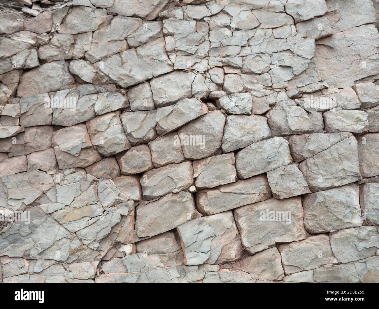 Broken rock in a cliff face. The rock is broken into rectangular shapes ...