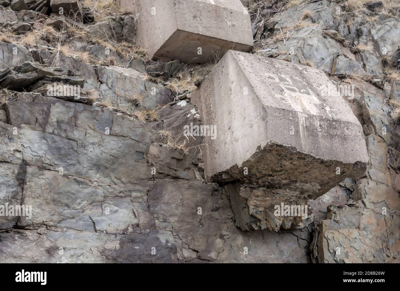 Concrete blocks on the side of a cliff. These blocks anchor the ends of ...