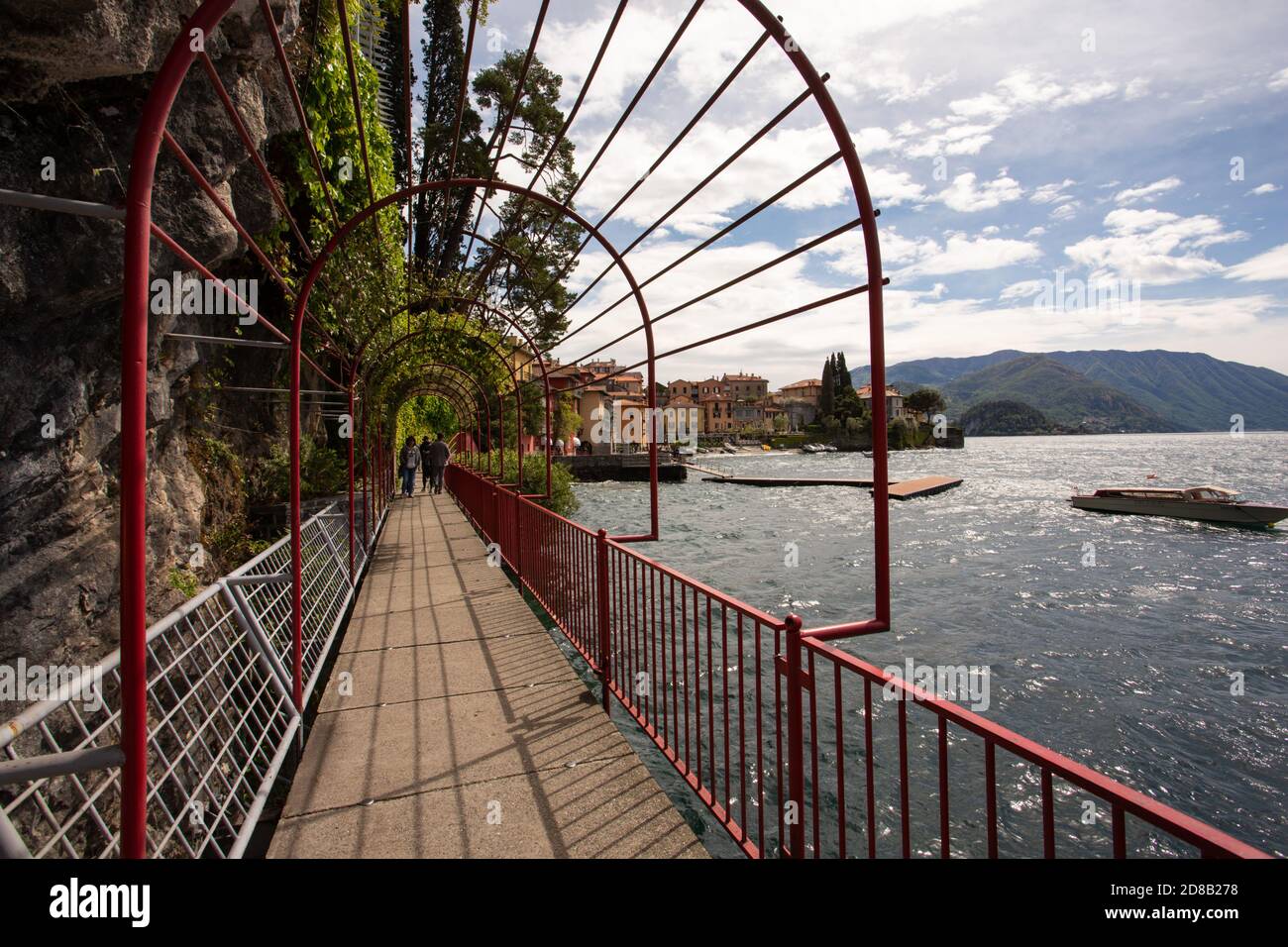 Red metal archway above boardwalk by Lake Como in Varenna Stock Photo ...