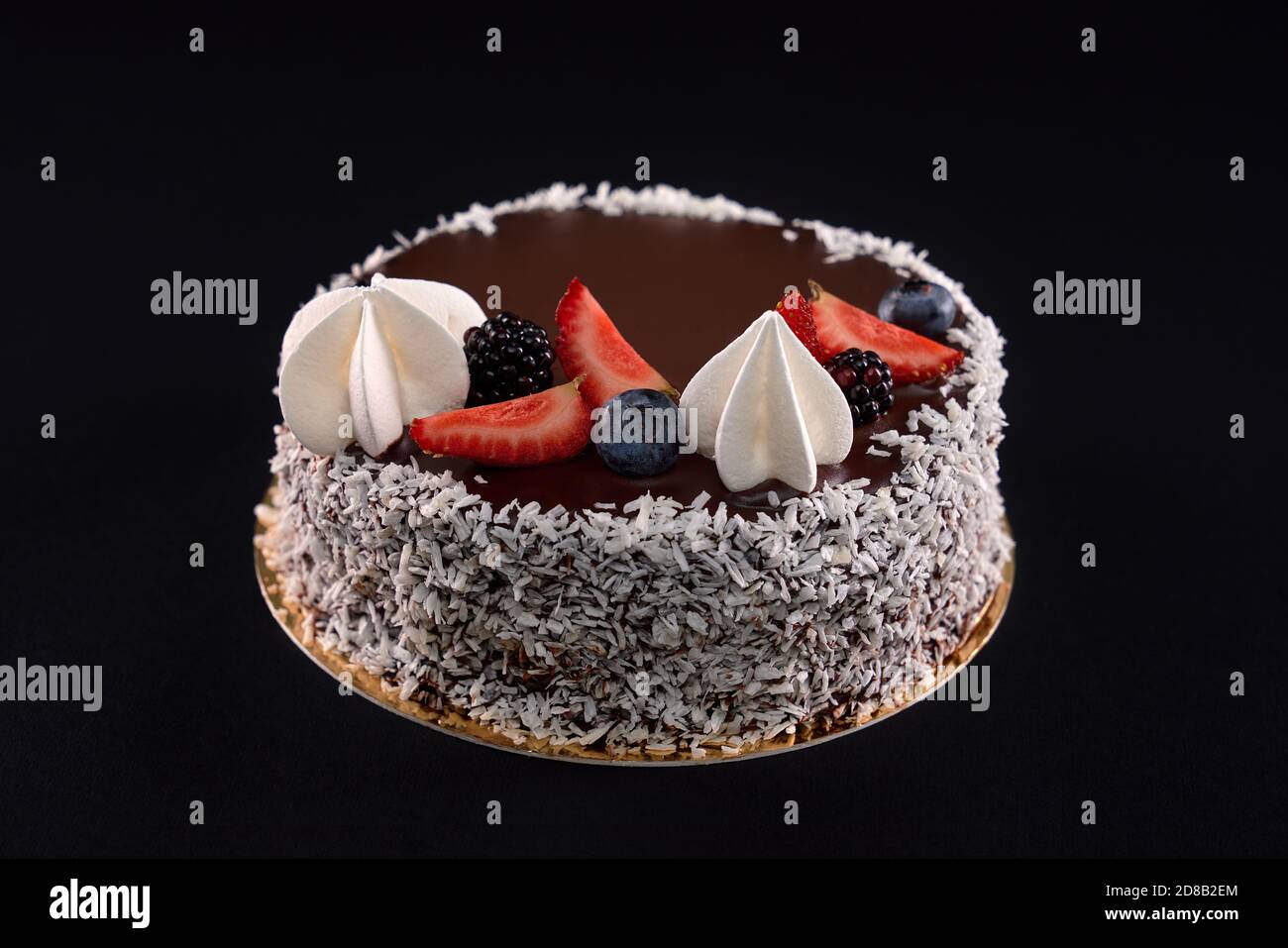Closeup view of tasty brown cake decorated with coconut shaving on ...