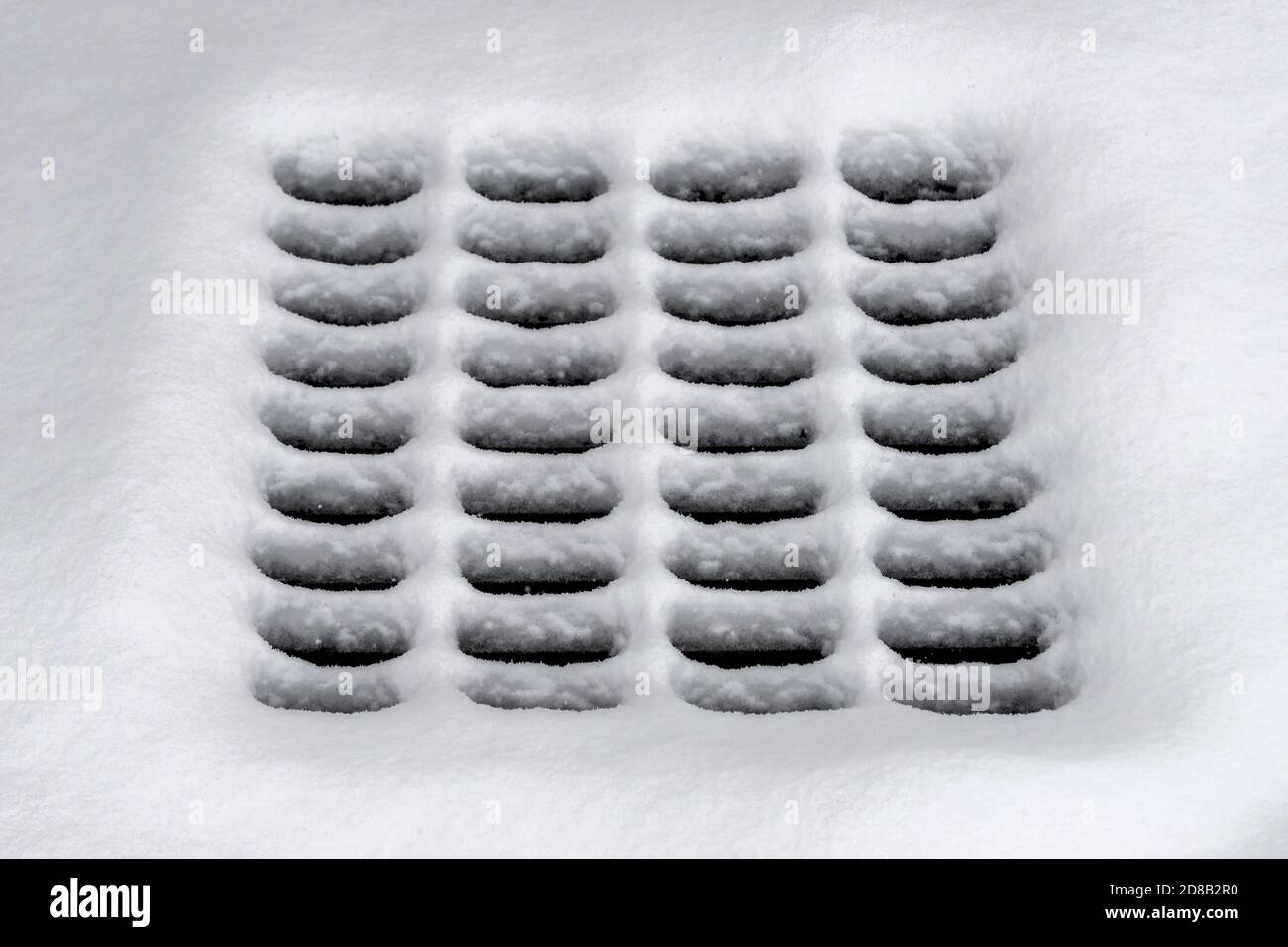 A snow covered storm grate. The snow is fresh and undisturbed Stock ...
