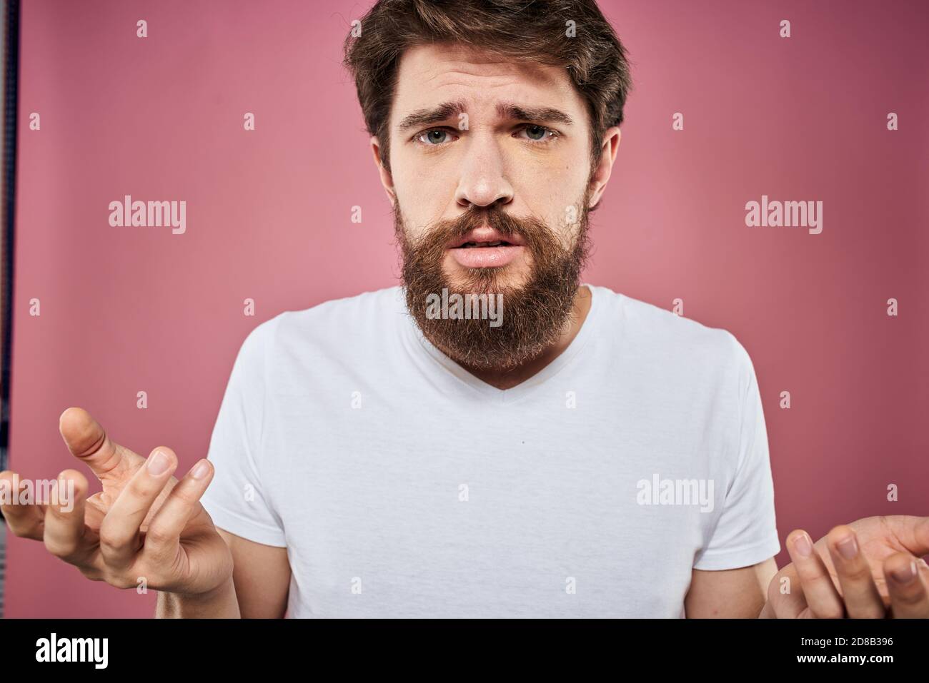 bearded man in white t-shirt emotions displeased facial expression ...