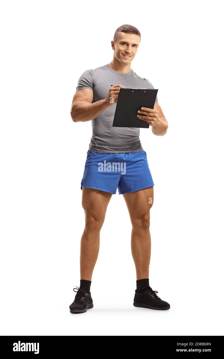 Full length portrait of a muscular fitness instructor writing on a ...