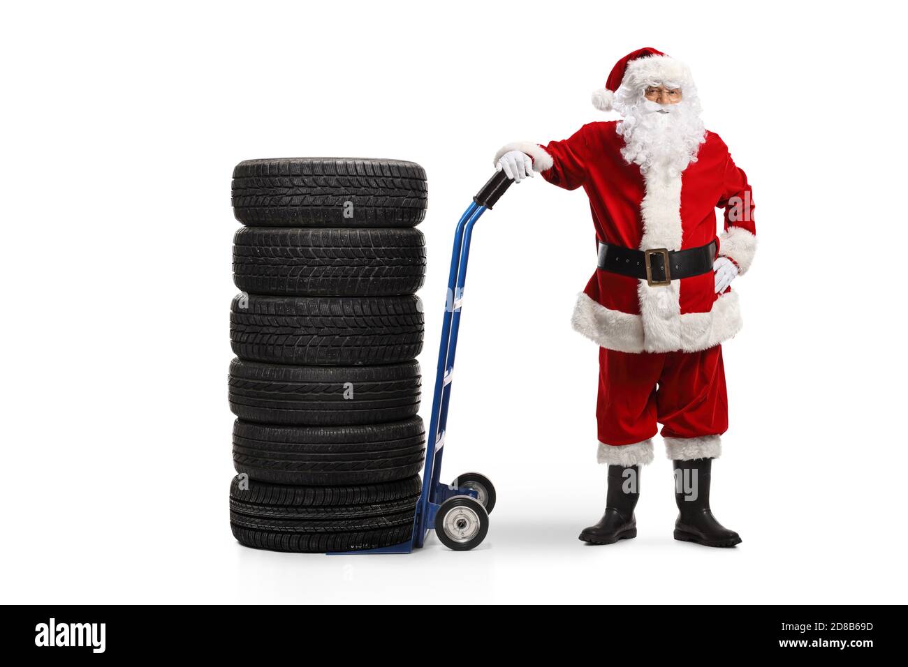 Full length portrait of a Santa Claus auto mechanic with car tires on a ...