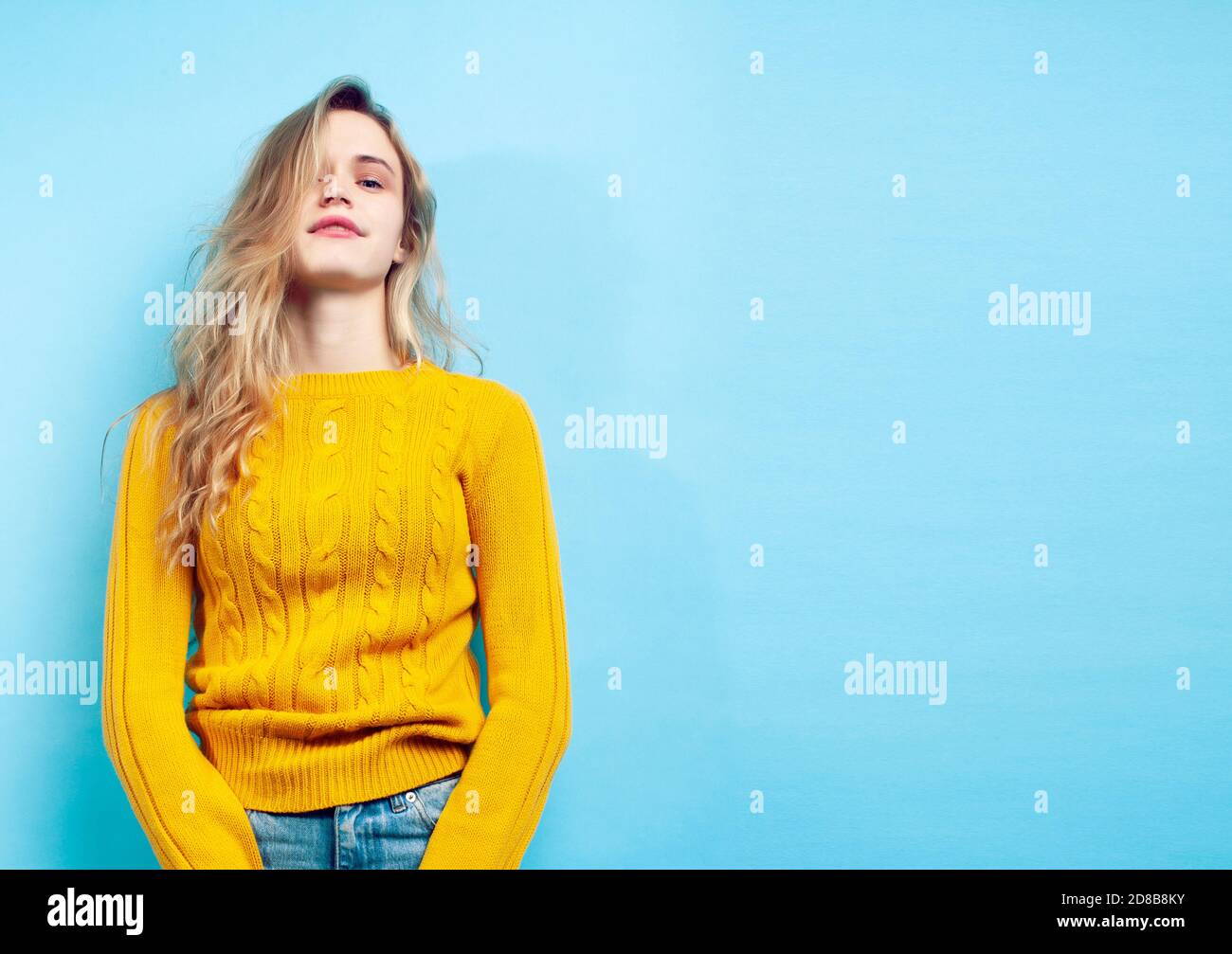 young pretty teenage modern hipster girl posing emotional happy on blue ...