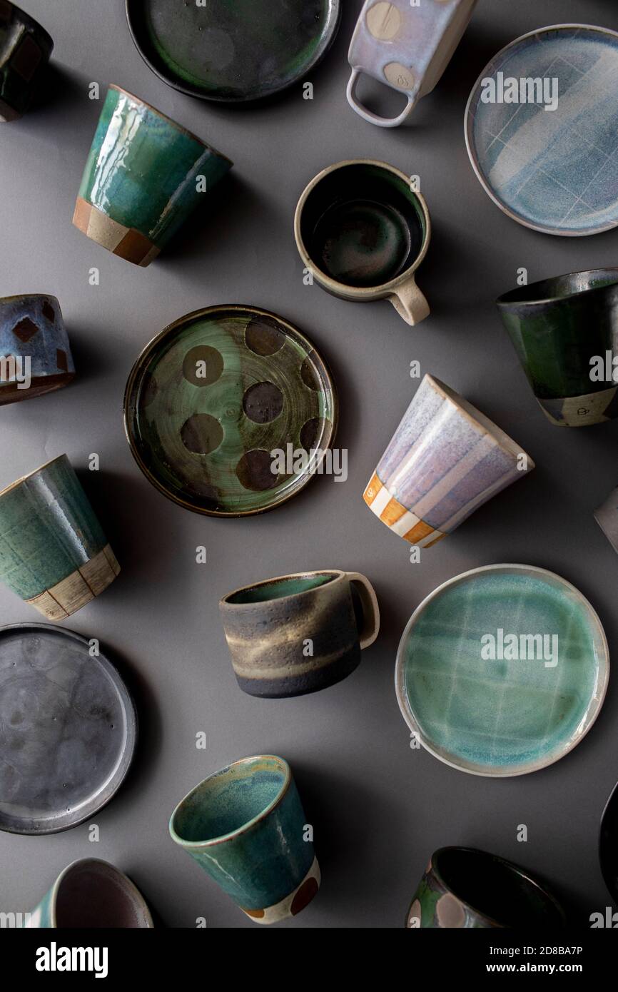 Ceramic cups, plates, and mugs on gray surface Stock Photo - Alamy