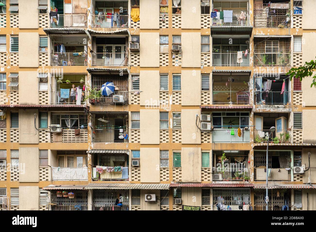 The balconies of an apartment building are hung with clothes. The poor ...