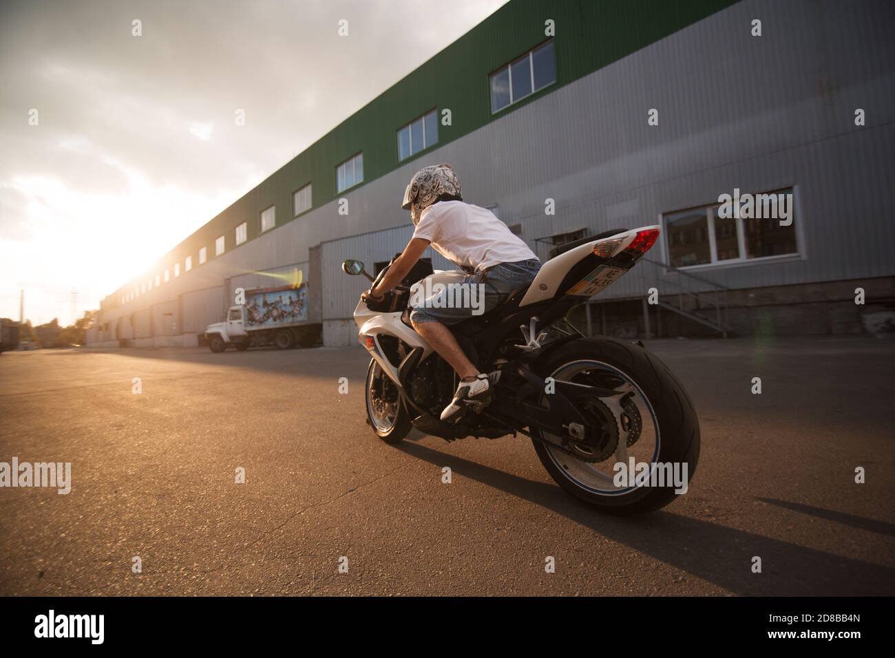 A young guy and a powerful sports bike. Photo on the street Stock Photo ...
