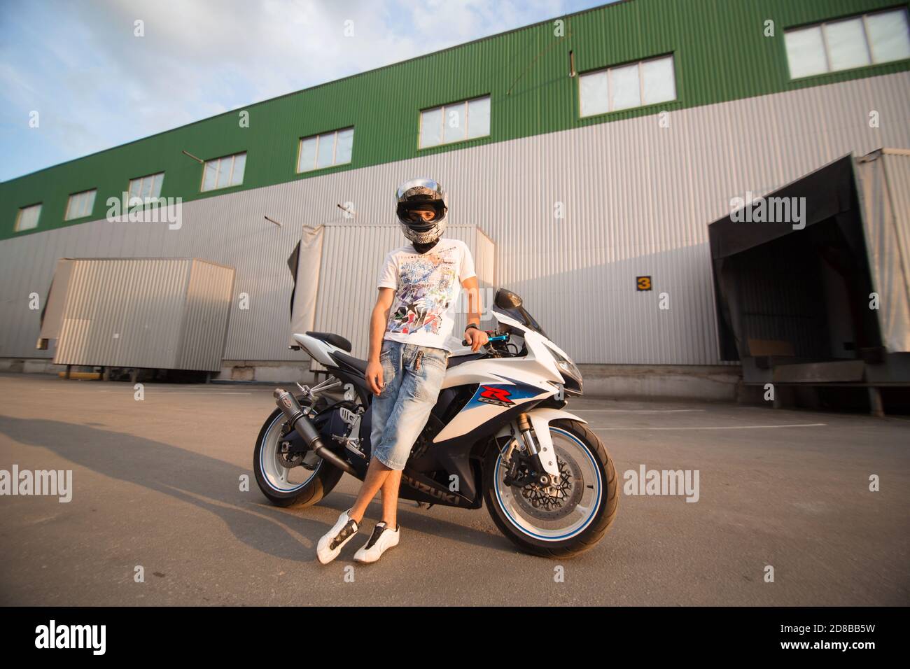 A young guy and a powerful sports bike. Photo on the street Stock Photo ...
