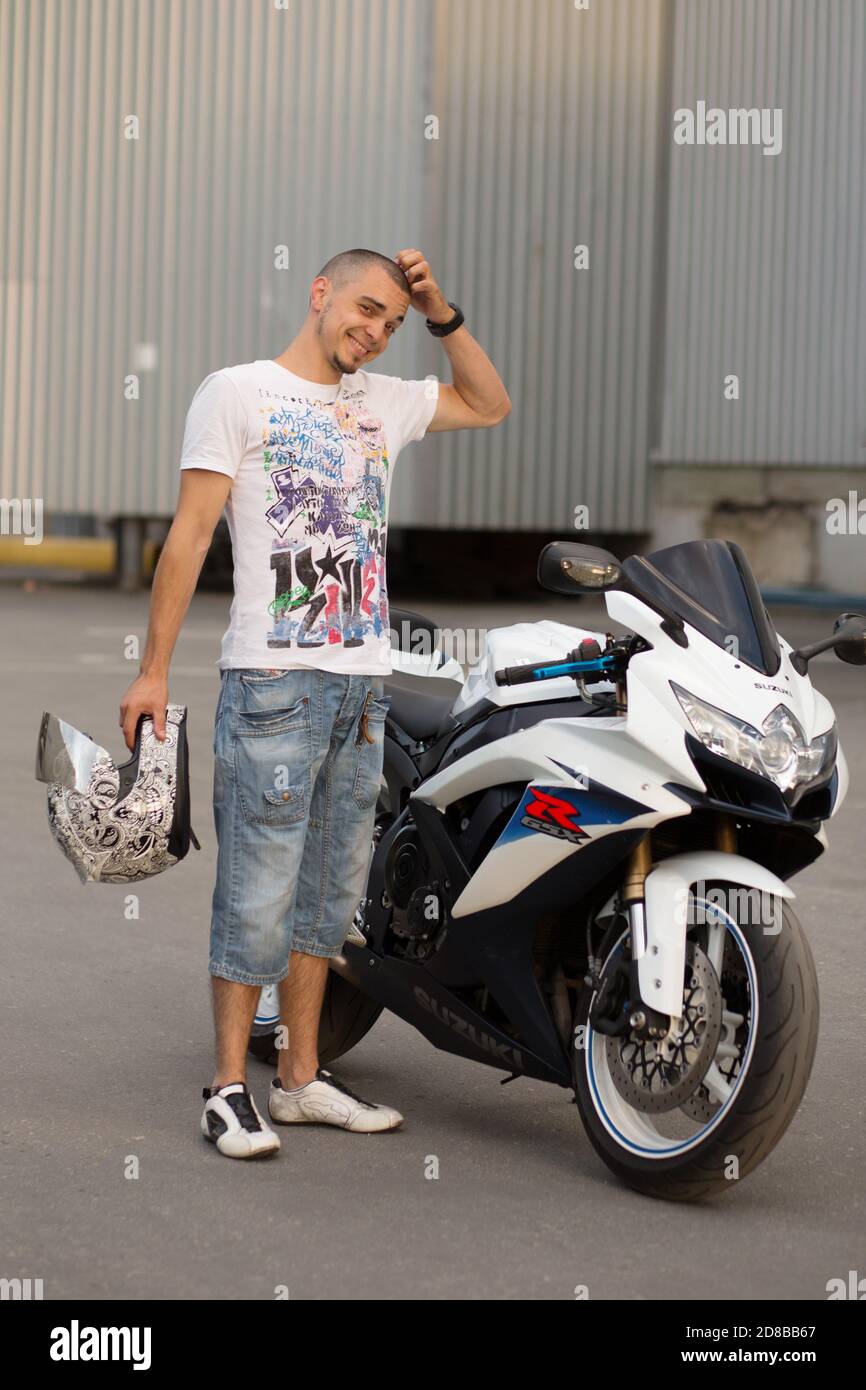 A young guy and a powerful sports bike. Photo on the street Stock Photo ...