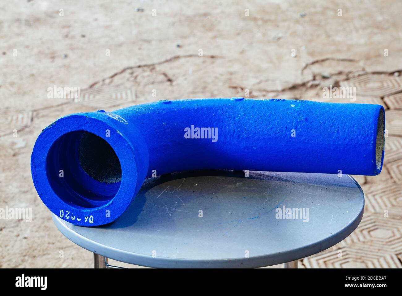 Cast metal pipe connection on gray table Stock Photo - Alamy