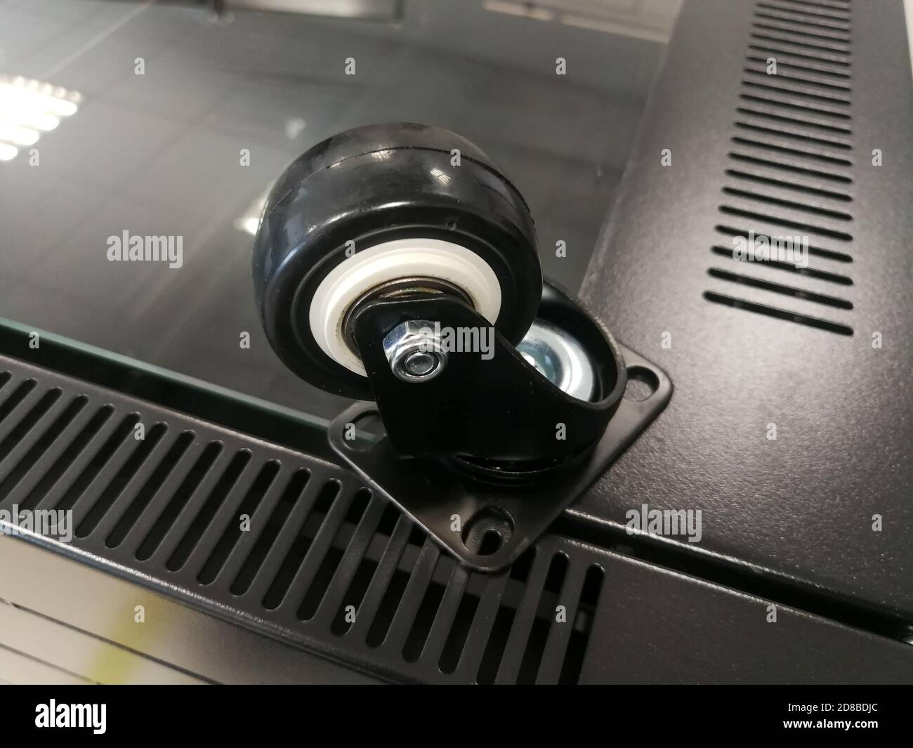 Rubber coated furniture wheel prepare to be fixed on metal rack Stock ...