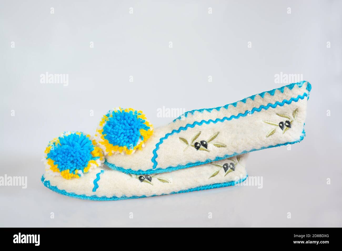 Greek wool slippers with pumpons on a light background Stock Photo - Alamy