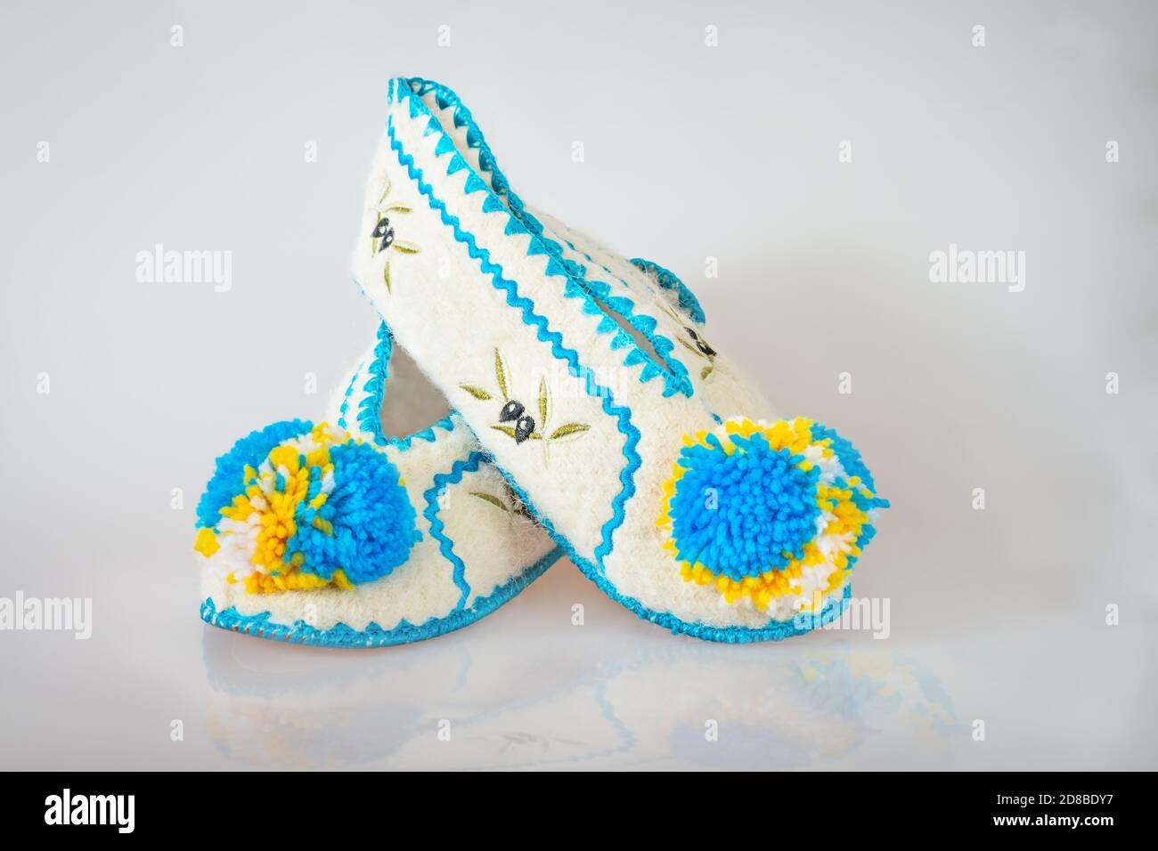 Pair of Greek slippers with pumpons on gray background Stock Photo - Alamy