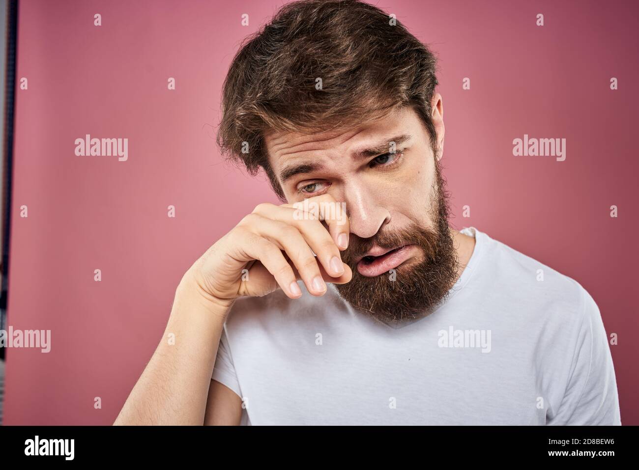 bearded man in white t-shirt emotions displeased facial expression ...