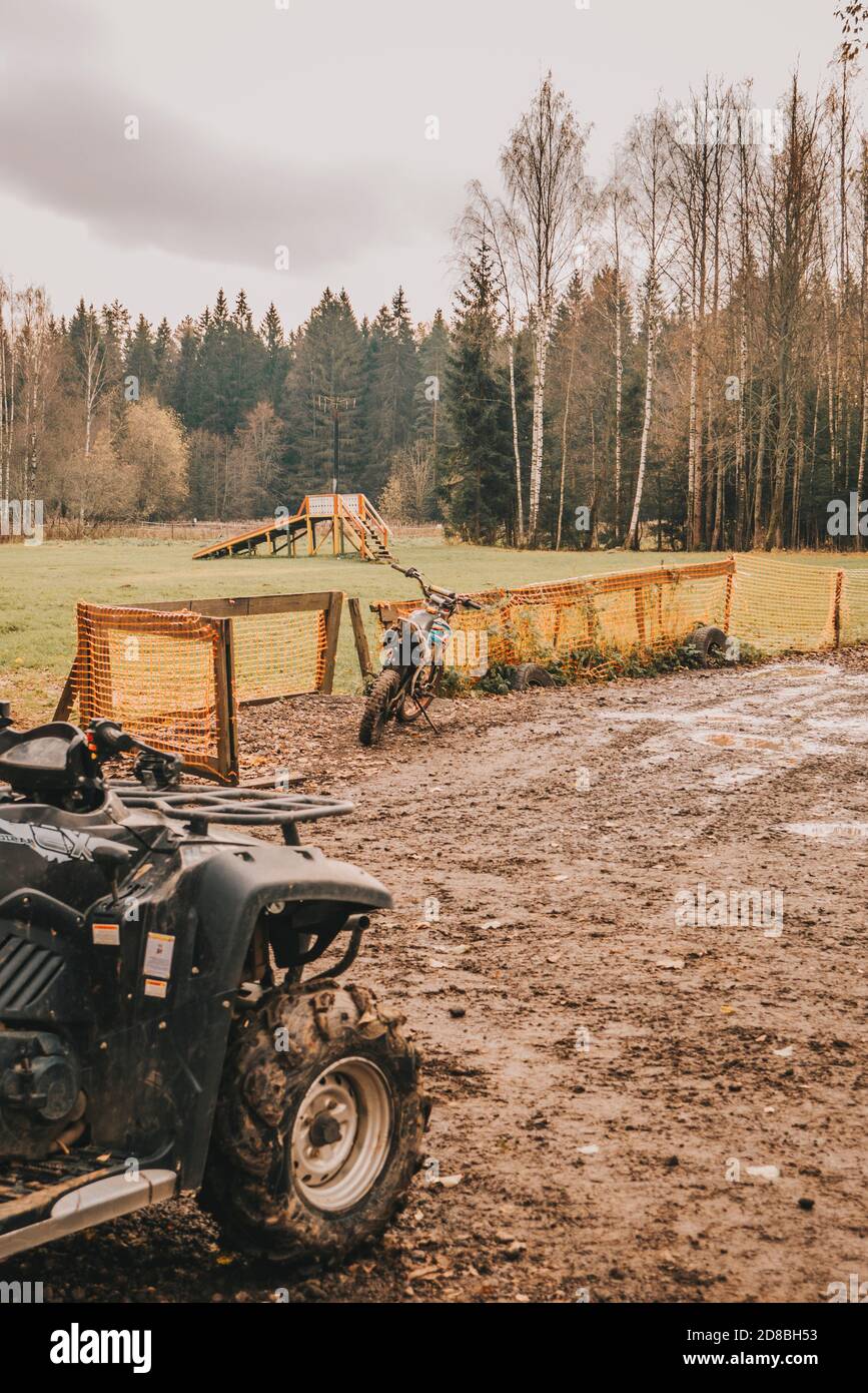 A quad bike and a motorcycle in the mud Stock Photo - Alamy