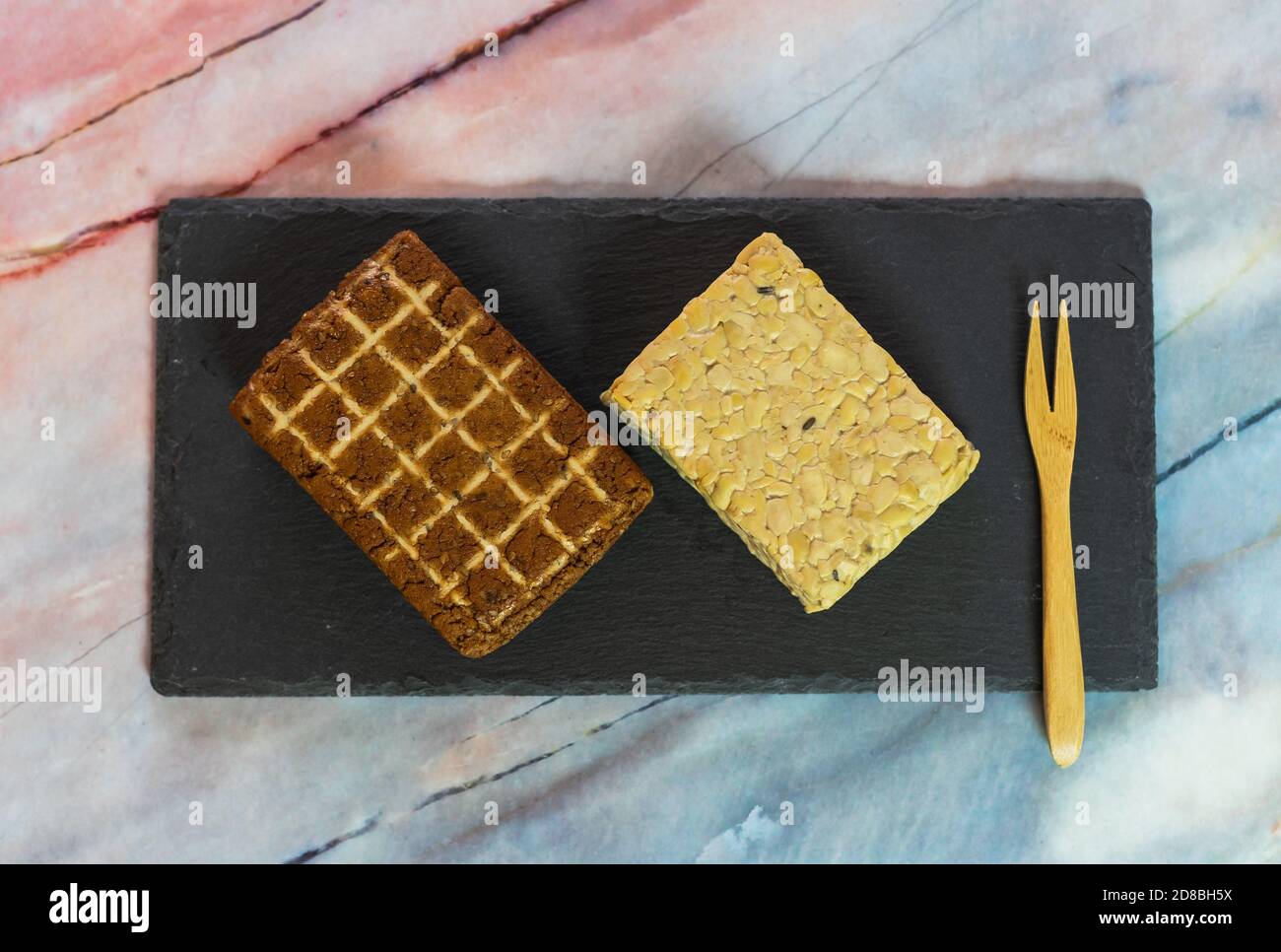 Two pieces of soy products. Smoked tofu and tempeh. Healthy protein ...