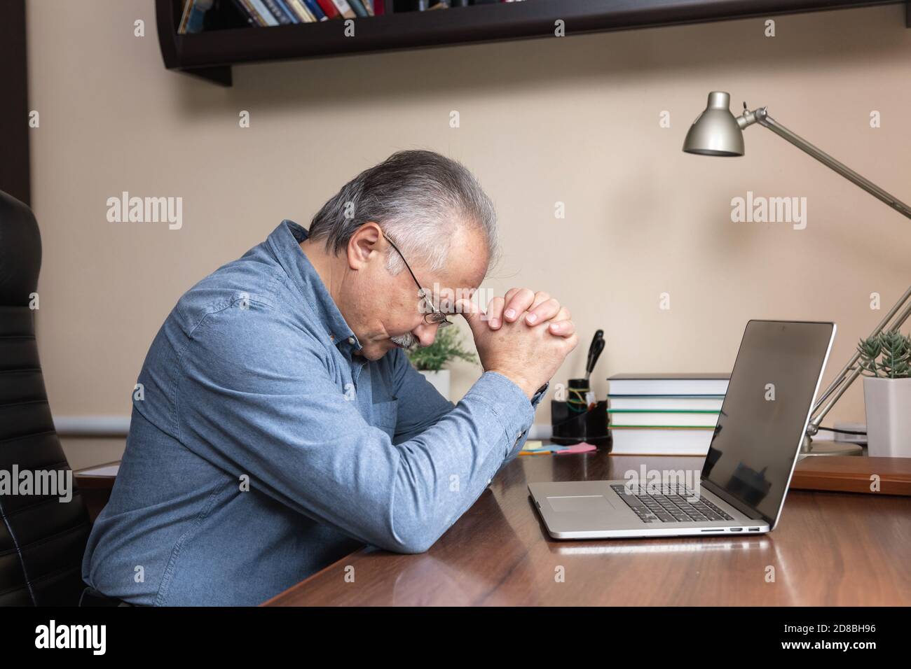 Senior man learn to use computer. Old man in glass and blue shirt using ...