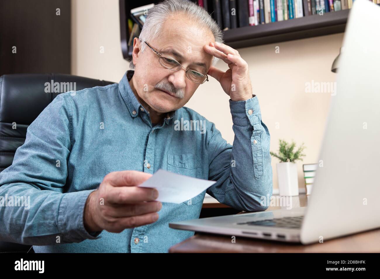 Senior man learn to use computer. Old man in glass and blue shirt using ...