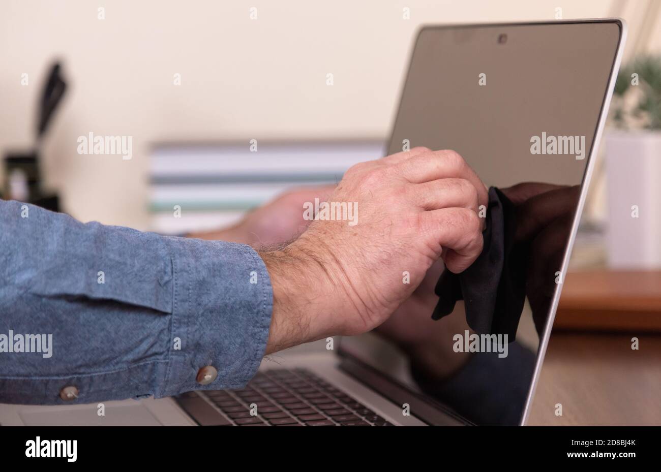 Cleaning laptop Screen. man hands cleaning laptop computer screen with ...