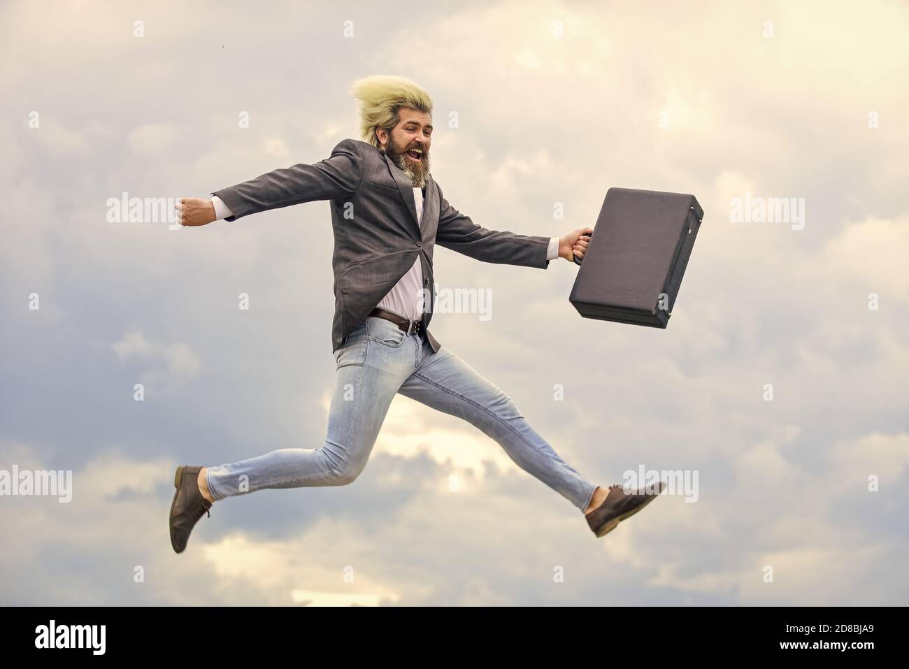 winning. feeling free and lucky. successful businessman jump high with ...