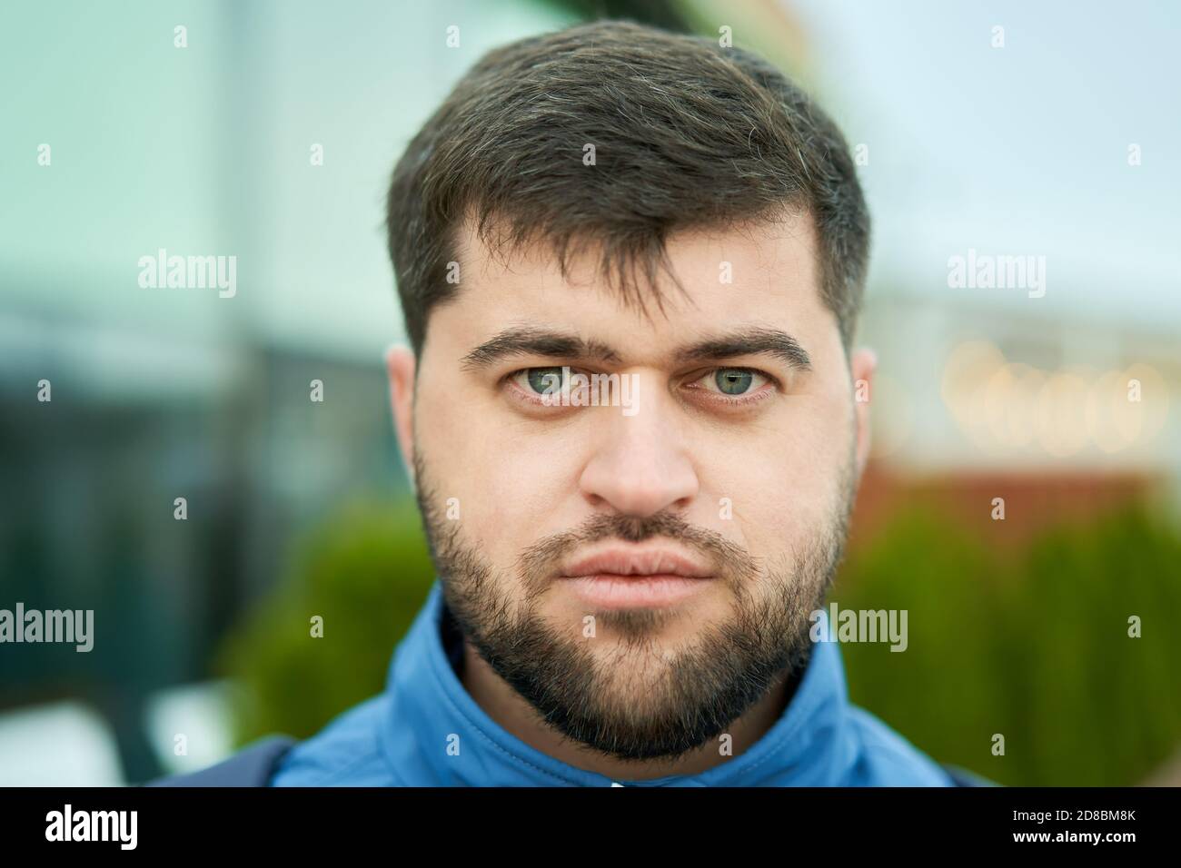 Serious young bearded man is walking outside at summer Stock Photo - Alamy