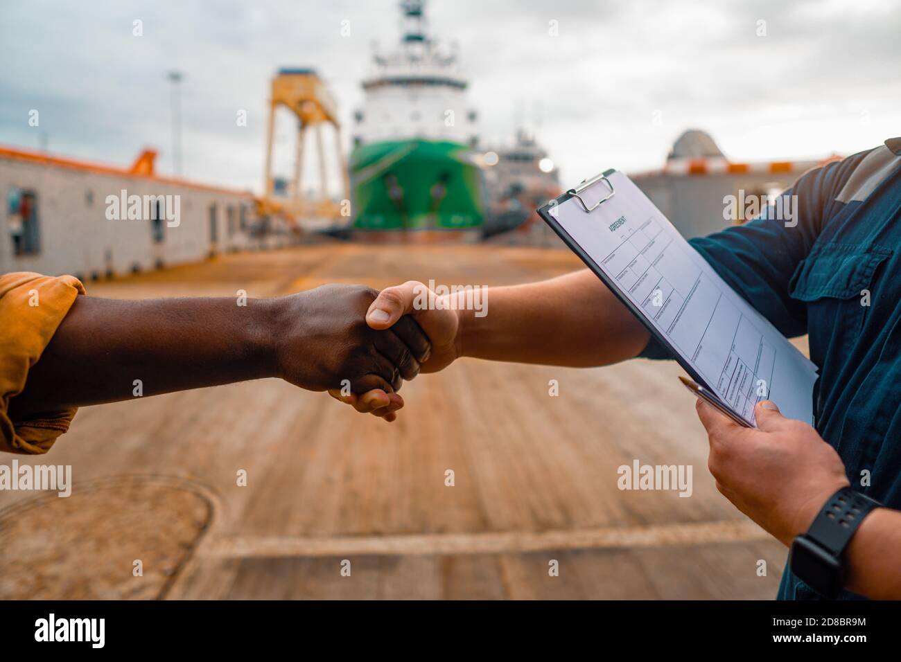 marine contractor businessman handshaking with worker on the ship Stock ...