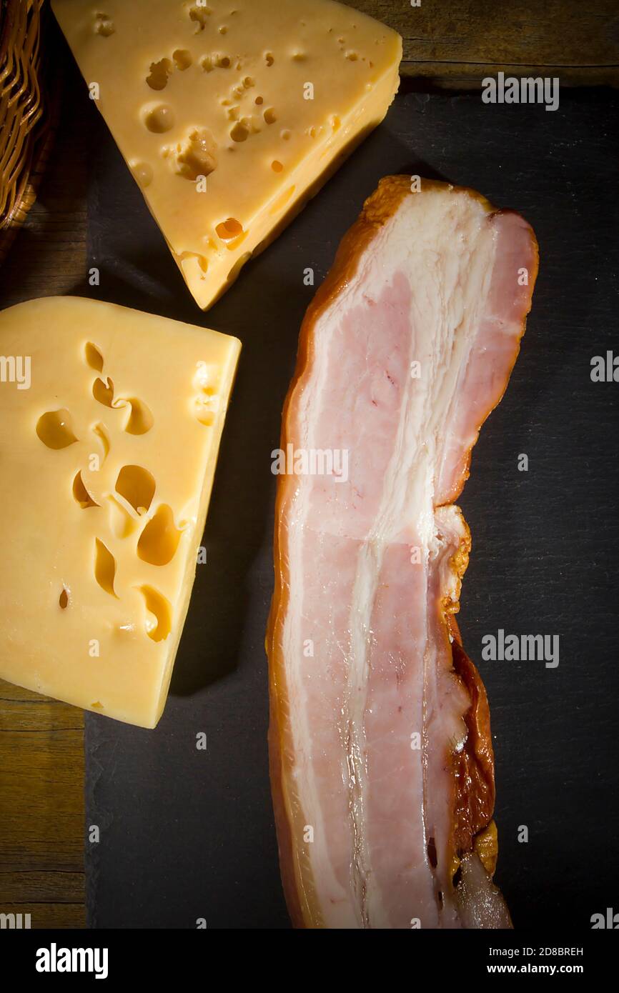 Cheese and bacon on a cutting stone board Stock Photo - Alamy