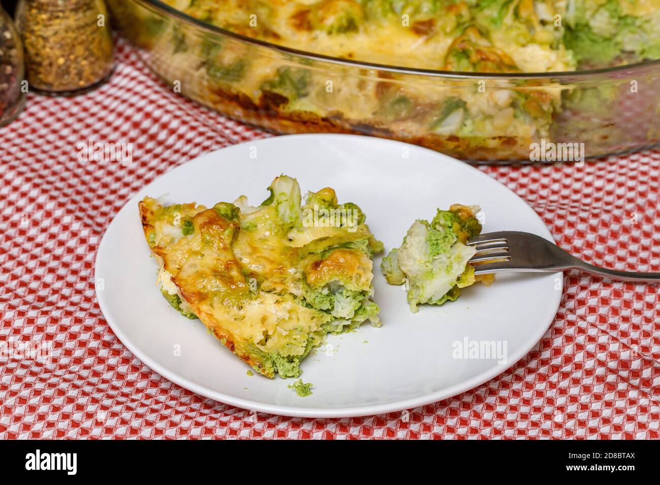 Baked broccoli baked with cheese on white plate Stock Photo - Alamy