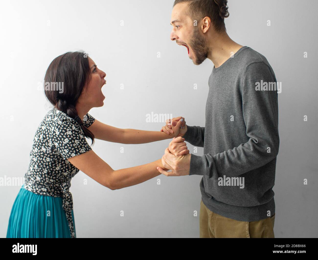 Caucasian Hispanic Couple Hold Hands while Yelling at Each Other Stock ...