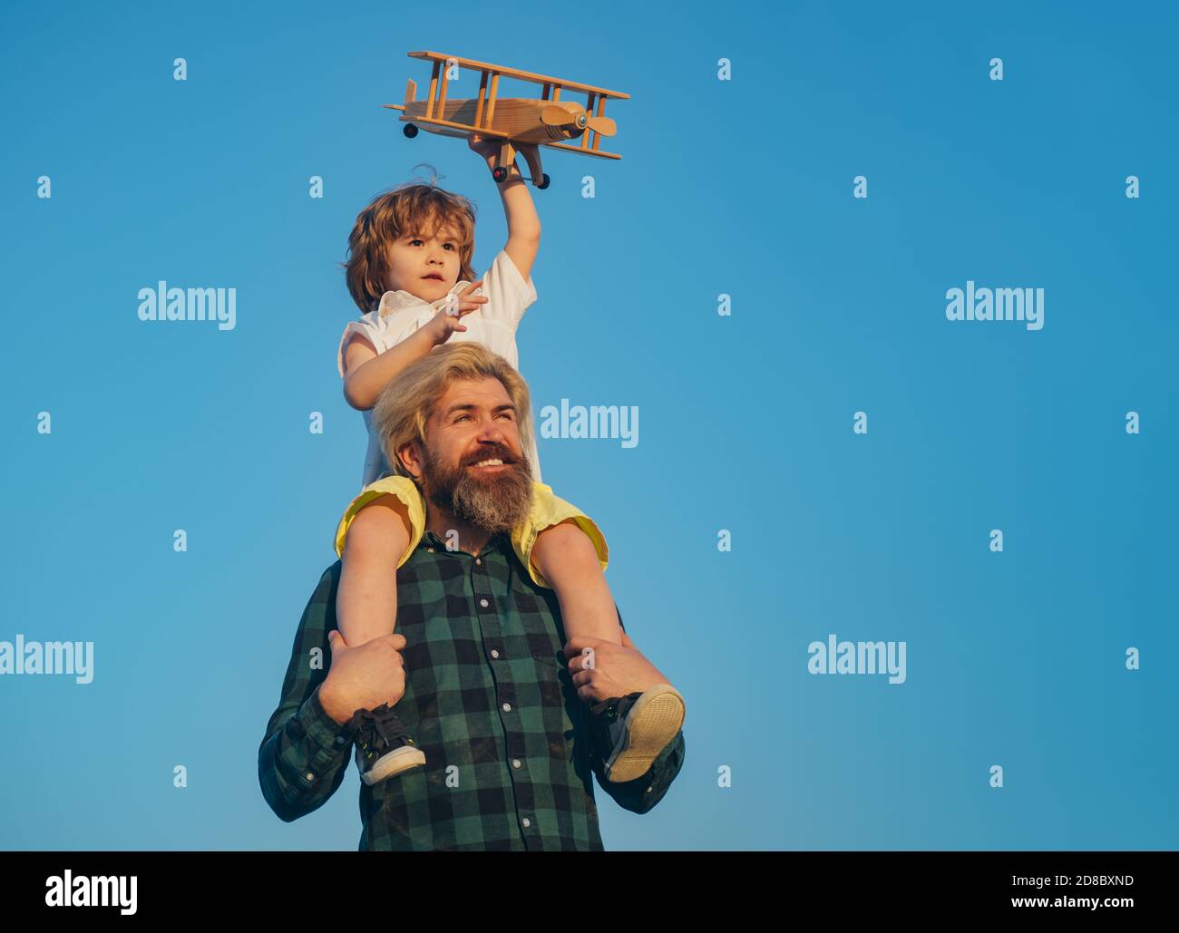 Happy father giving shoulder ride on his shoulders. Father and son ...