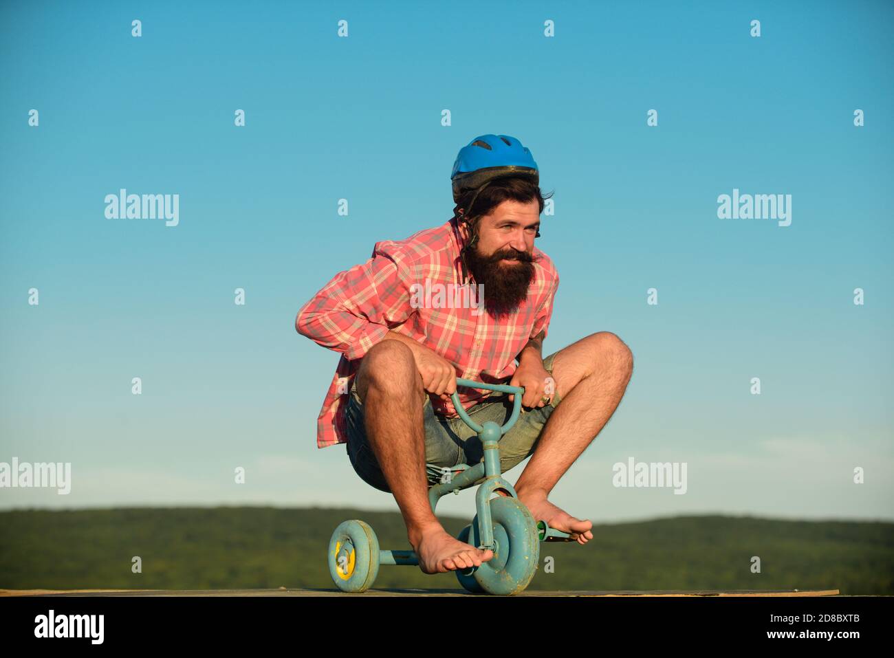 Funny crazy man is riding a bike Stock Photo - Alamy